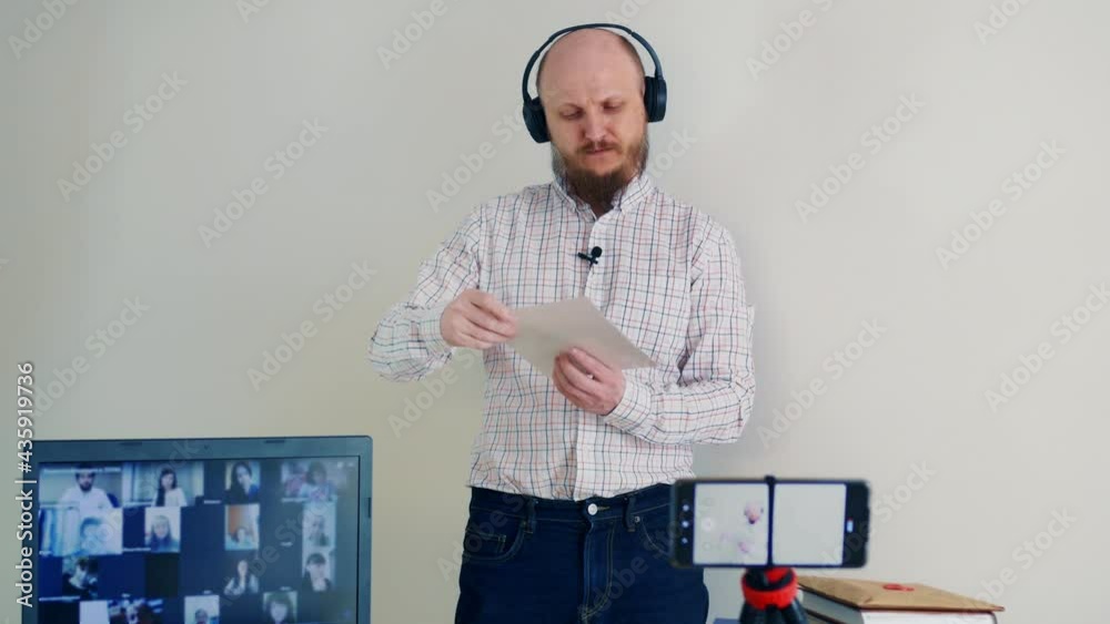A bald man with a beard conducts training online, the study of alphabet ...