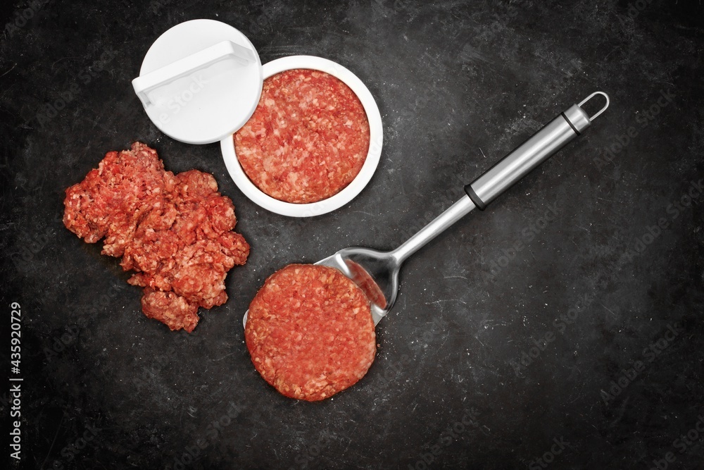 Patty Press and Raw Burgers on Wooden Board. Plastic Burger Stuffer ...