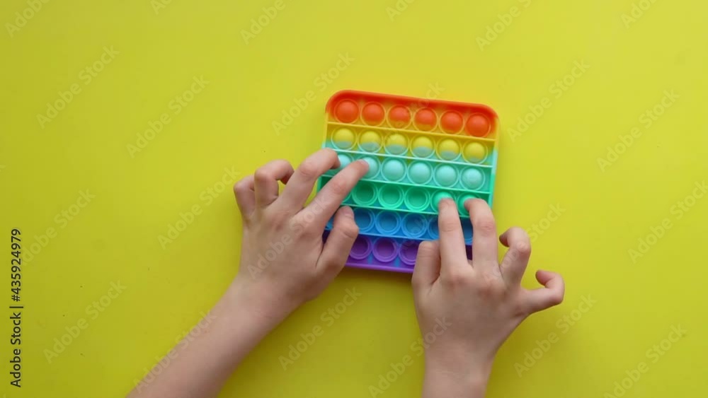 Popit antistress toy for children entertainment on a yellow background ...