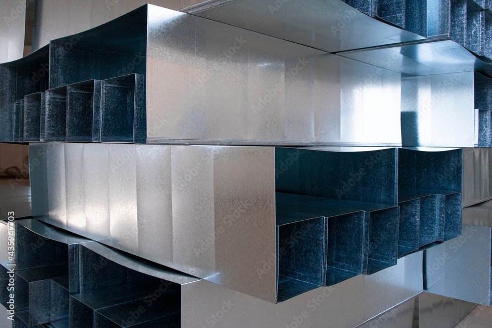 square air ducts neatly stacked in a ventilation system, foreground and ...