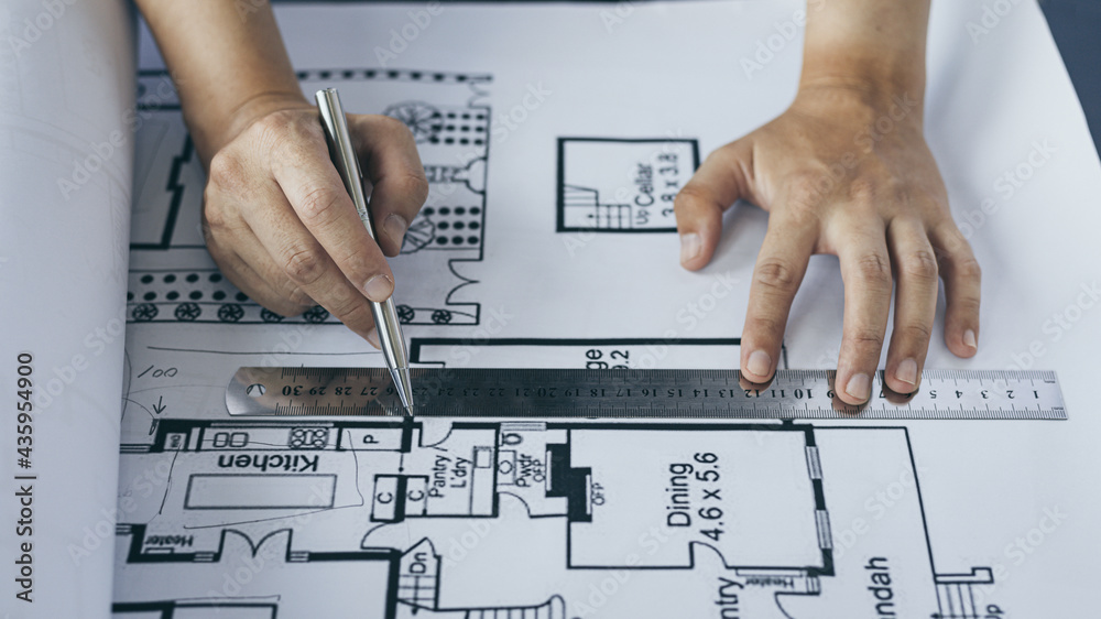 Engineer and Architect concept, Man uses a ruler to measure the floor ...