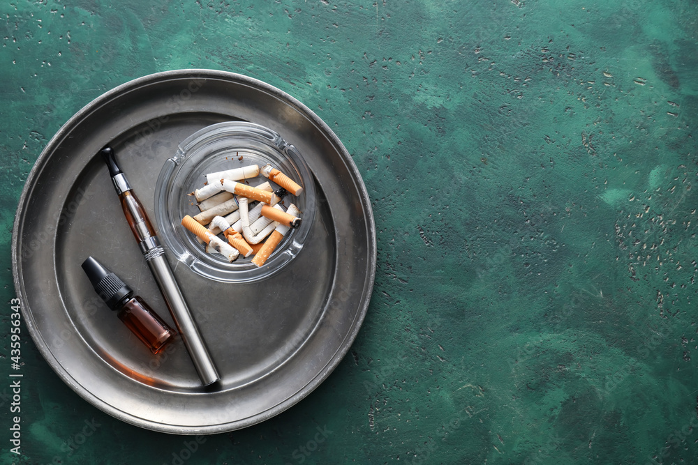 Tray with set for smoking with cigarette stubs on color background ...