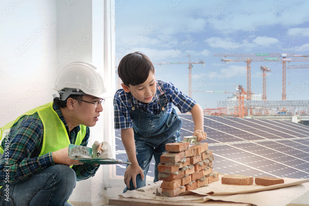Child boy is learning to install installing brick masonry with an ...