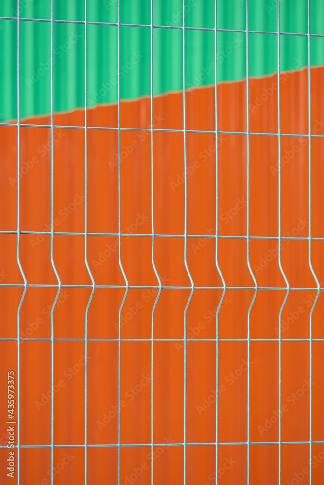 Prefabricated grating wire fence panel with blurred background of ...