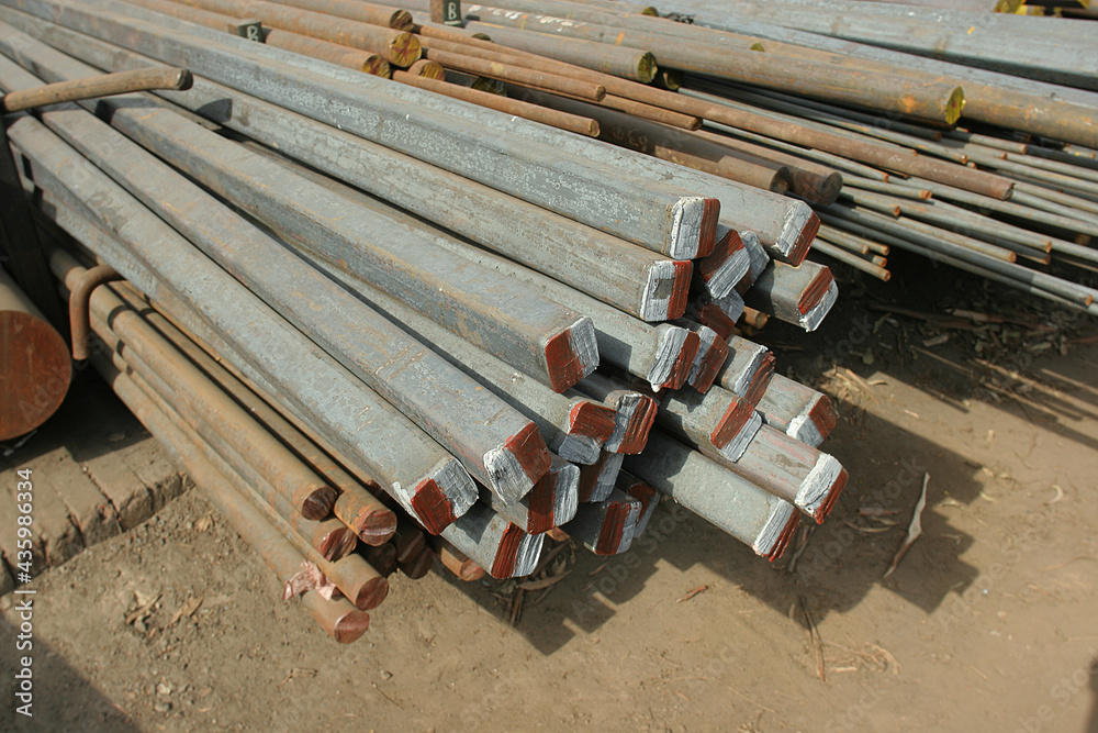 metal rods, steel bars and metal blanks with marking kept in warehouse ...