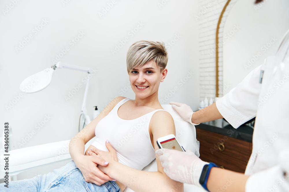 Smiling and happy female patient during a medical examination, when the ...