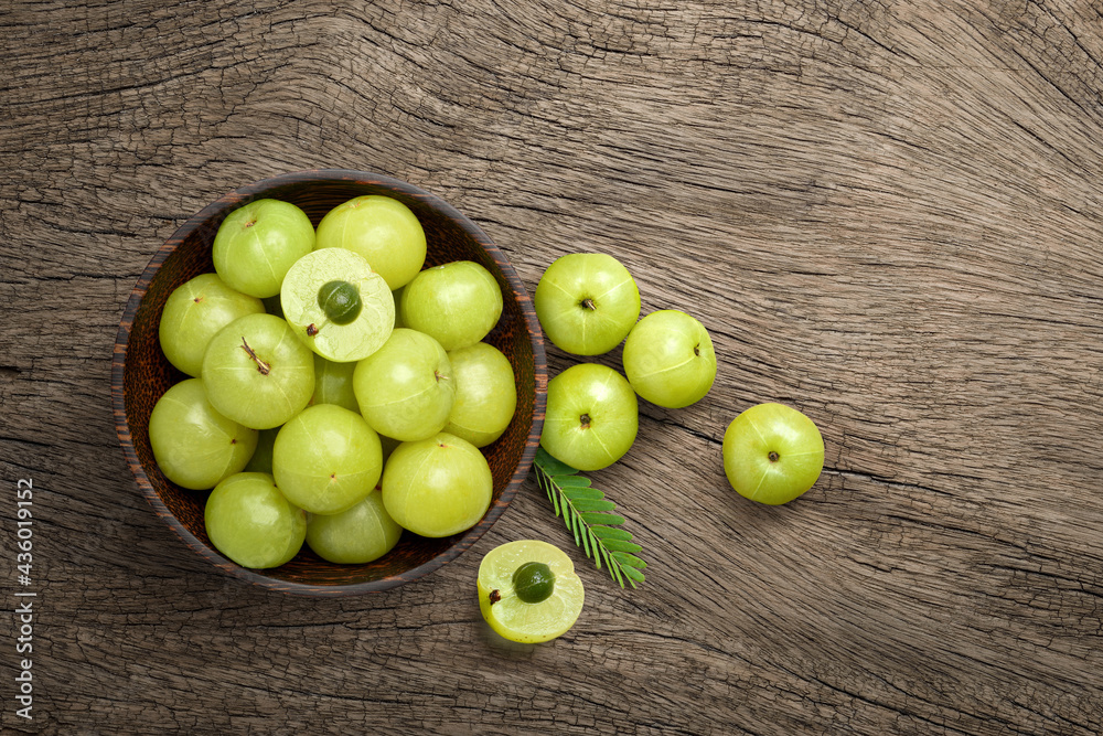Flat lay of Fresh amla (Indian gooseberry) fruits on old wood ...
