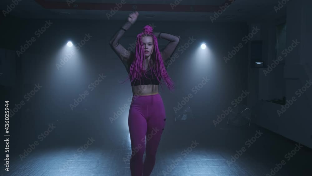 Graceful female dancing in studio with smoke and spotlight. Silhouette ...