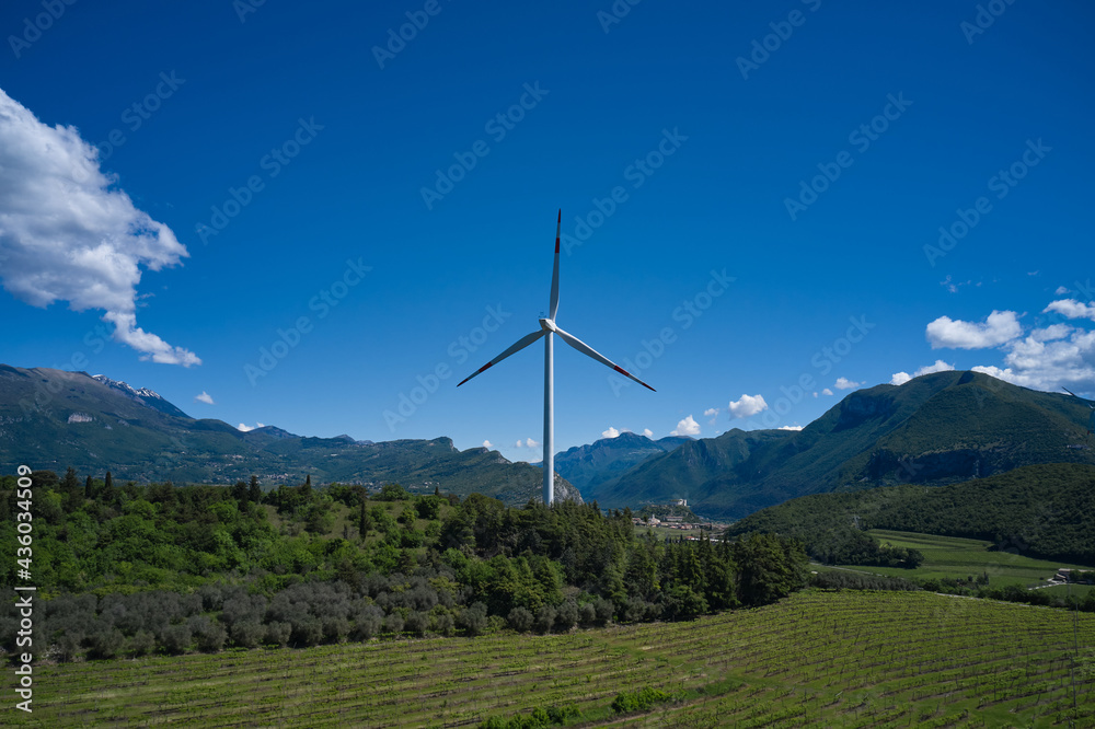 Wind generators in the mountains of Italy. Windmill surrounded by olive ...