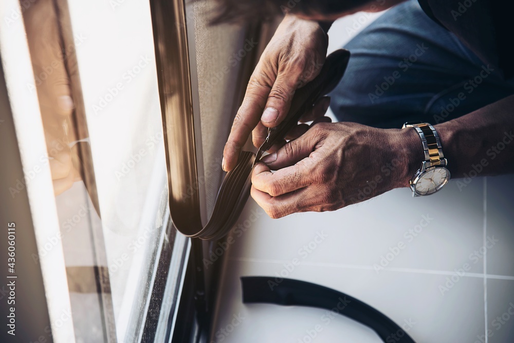 Man doing aluminum frame with glasses and wire screen door and window ...
