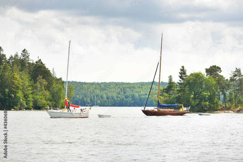 Classic and modern sloop rigged sailboats sailing in Mälaren lake on a ...