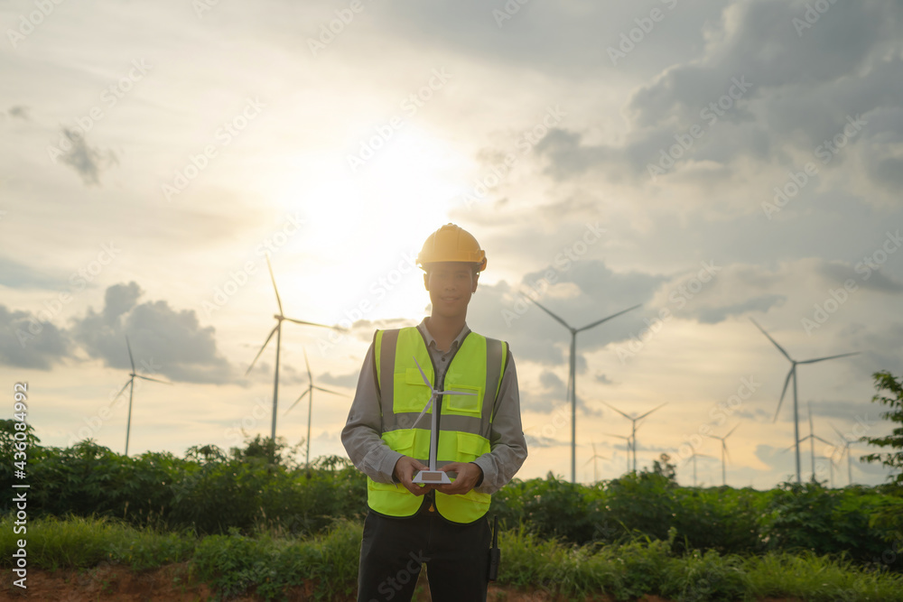 Portrait of Asian windmill engineer man, worker working, holding a ...