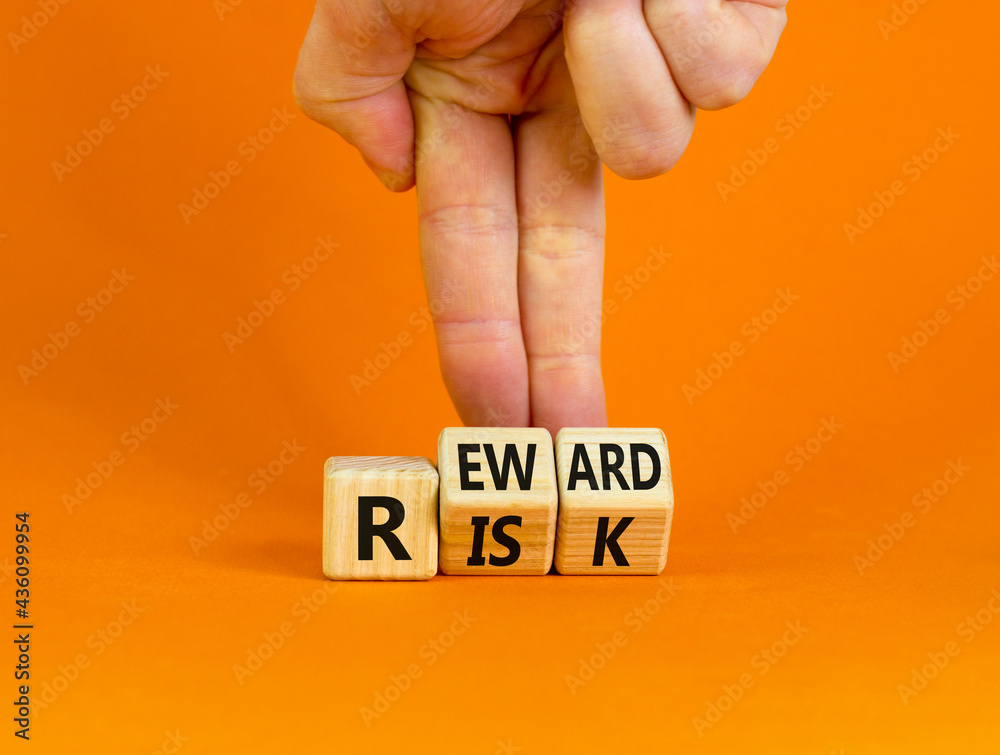 Risk or reward symbol. Businessman turns wooden cubes and changes the ...