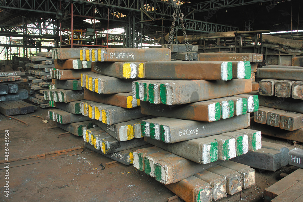 Ingots, steel bars and metal blanks with marking kept in warehouse ...