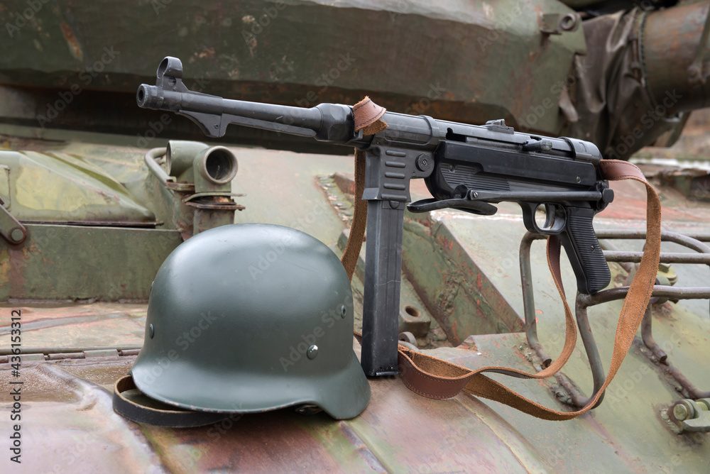 German submachine gun and helmet on the armor of the tank Stock Photo ...