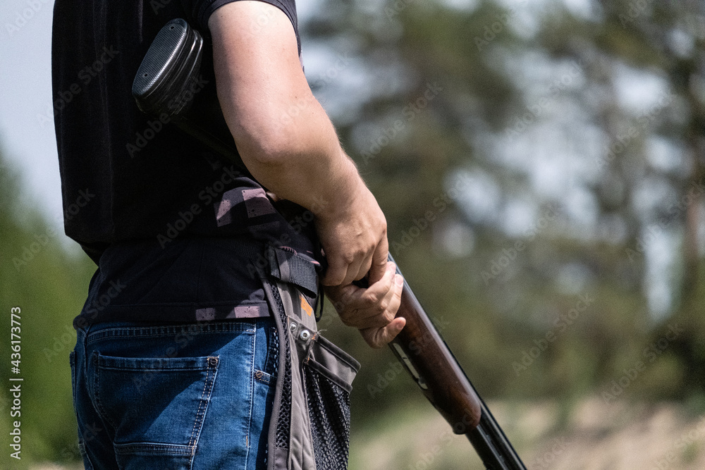 Hunting rifle firing. Hunting in the forest. Hunter loading gun with ...