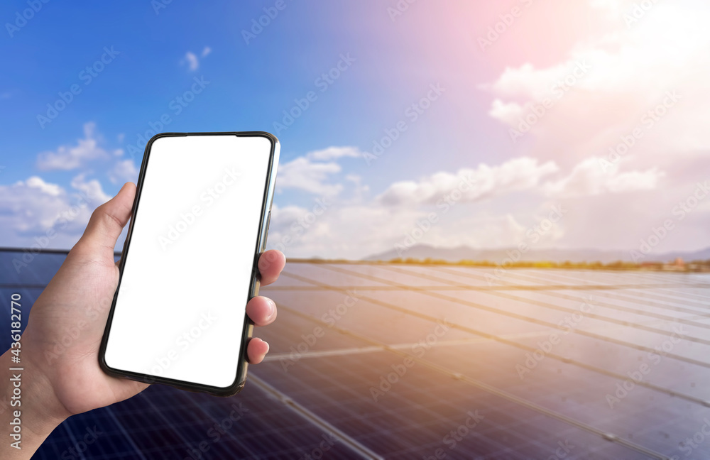 Mockup Mobile phone holding in hand with blurred solar roof background ...