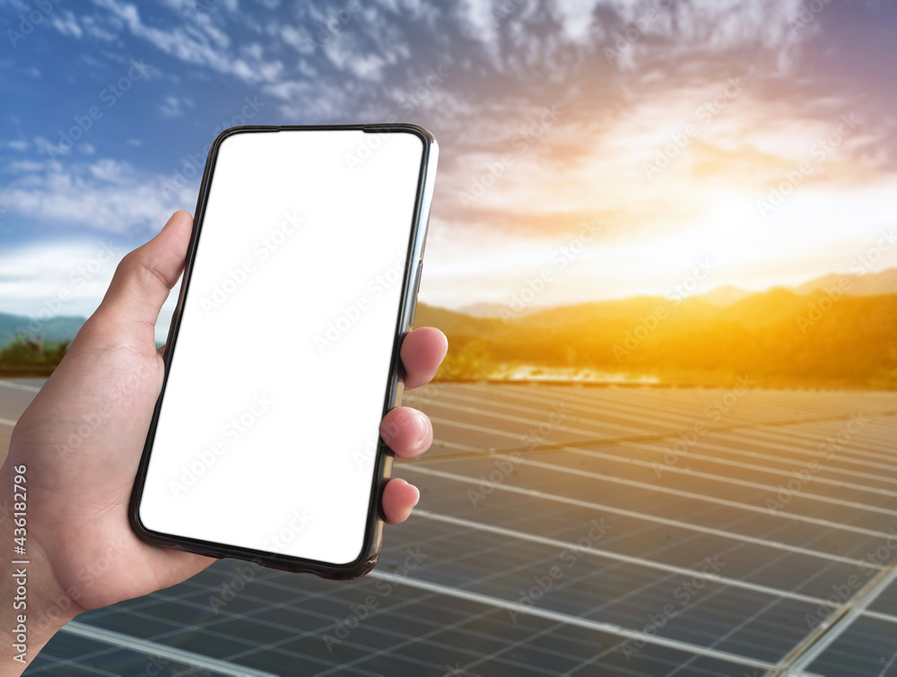 Mockup Mobile phone holding in hand with blurred solar roof background ...