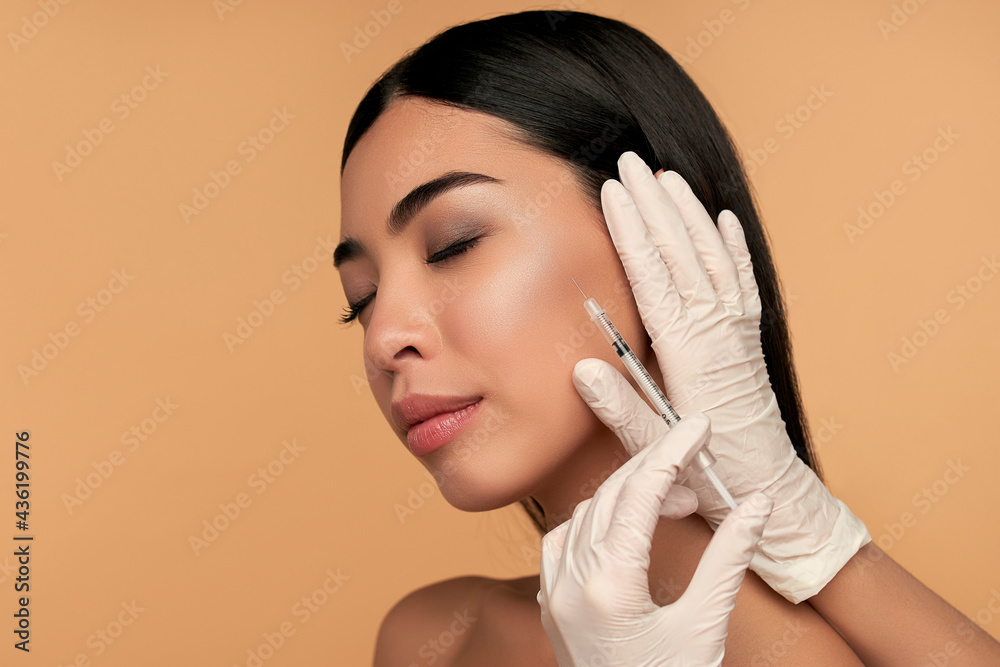 Young Asian woman with clean radiant skin gets botox injections for ...