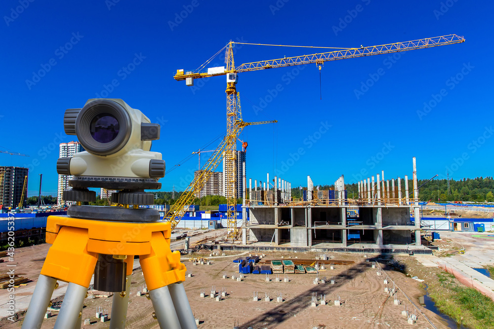 Geodetic device at a construction site. Surveyor. Total station next to ...