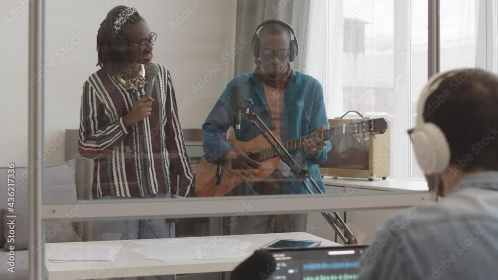 Back view of young beautiful African-American female singer singing ...
