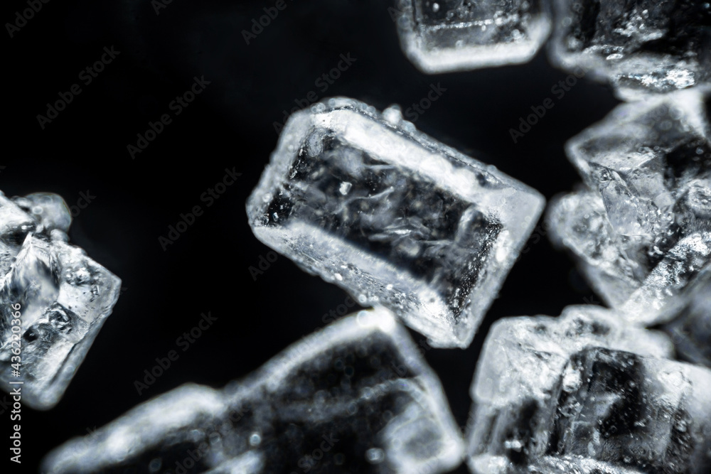 Crystal sugar macro on black background under the light microscope ...
