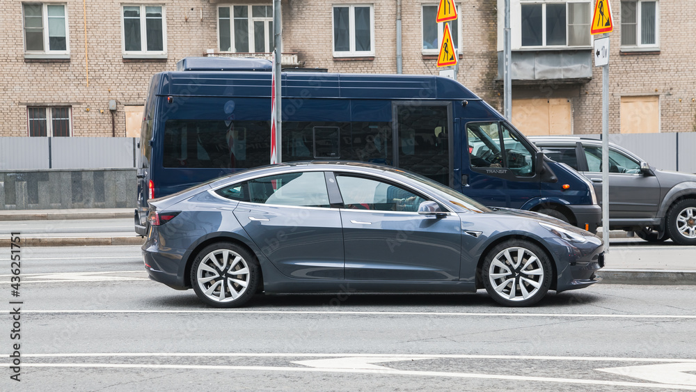 Gray color Tesla Model 3 car on street. The Tesla car is All-electric ...