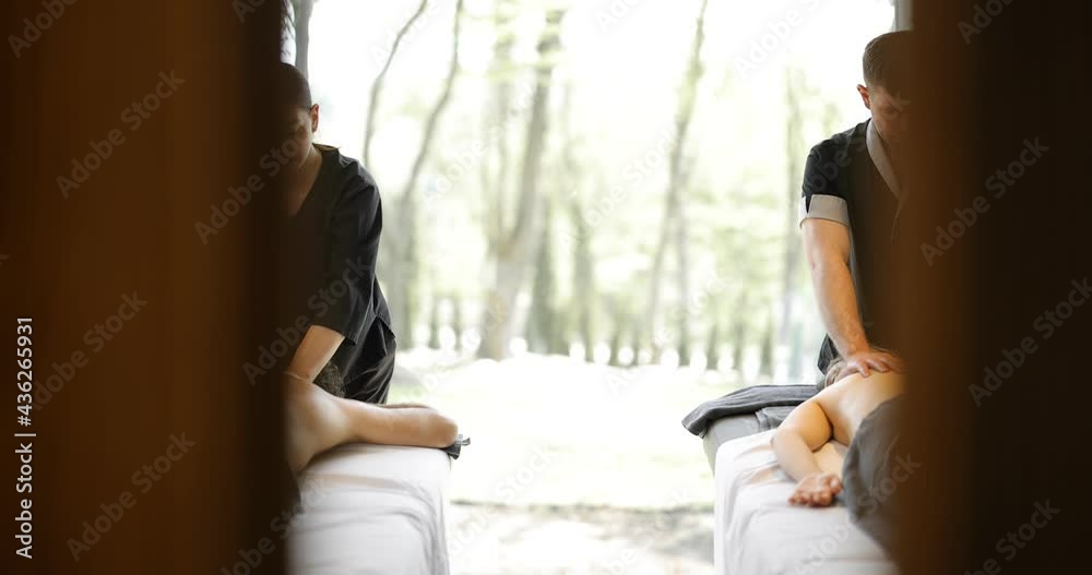 Two Masseurs Doing A Deep Synchronous Massage With Pampering Technique