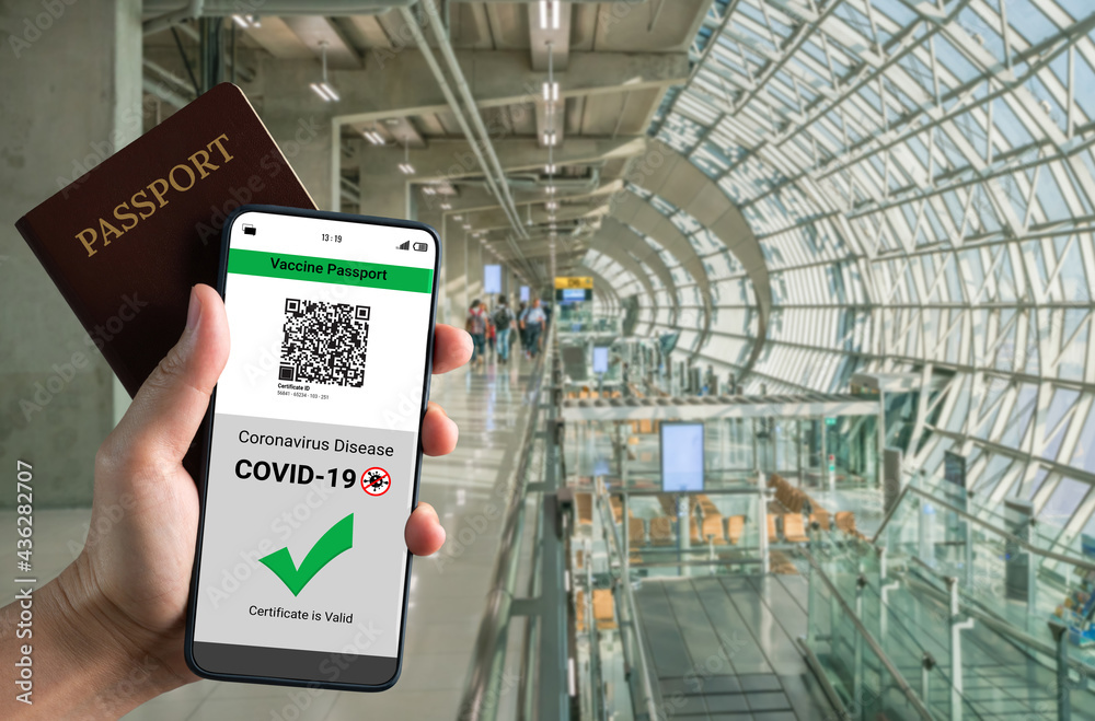 Traveler holds vaccine passport certificate to show COVID 19 ...