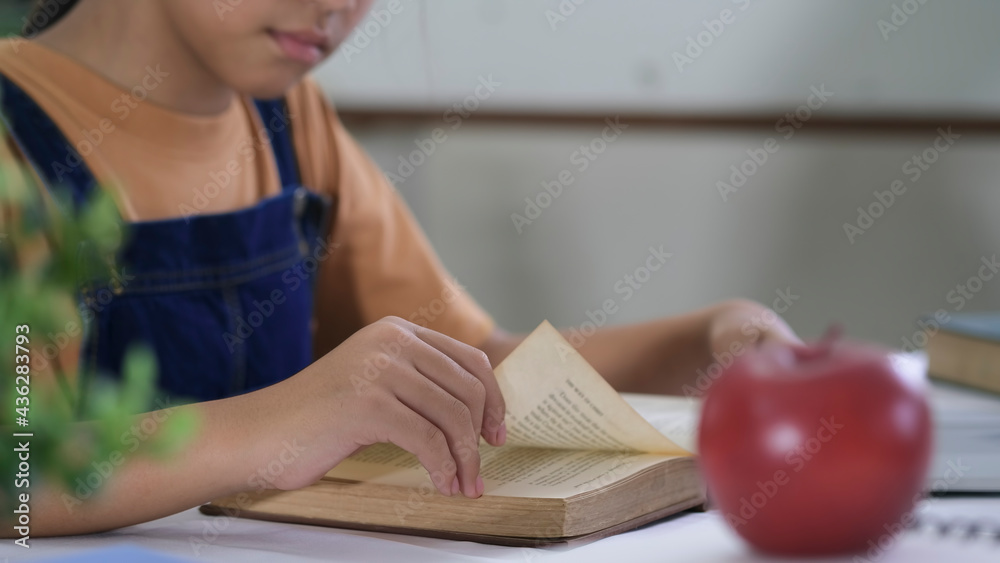 Young student makes exercise sitting at table. Students studying and ...