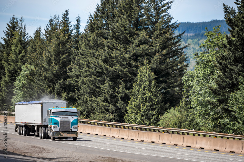 Old style cab over big rig semi truck transporting dusty cargo in ...