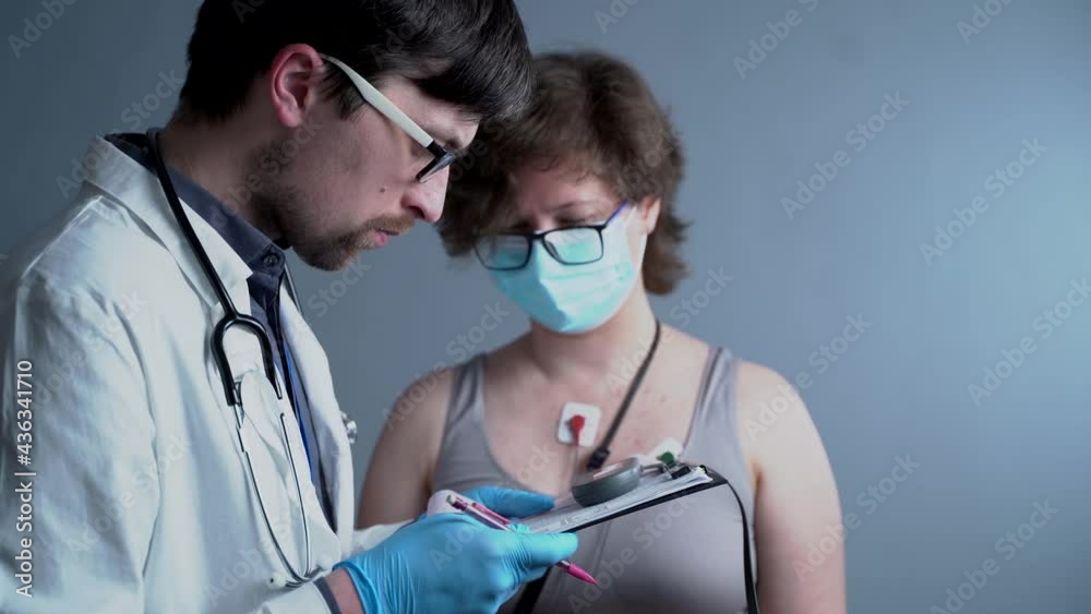 Young caucasian male doctor cardiologist do cardiological examination ... Young caucasian male doctor cardiologist do cardiological examination ...