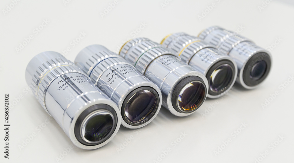 Detail of microscope lens on an white background.Closeup of microscope ...