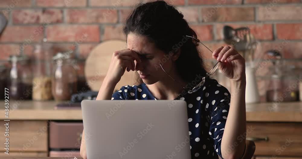 Unhappy young woman taking off eyeglasses, suffering from dry eyes ...