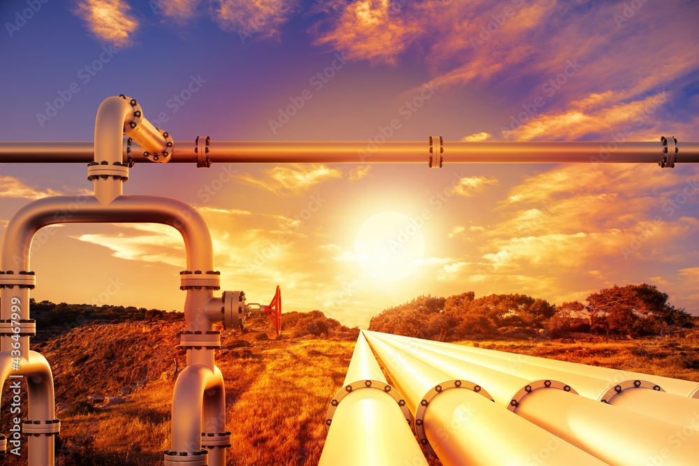 Pipeline and valves against the backdrop of sunset and mountainous ...