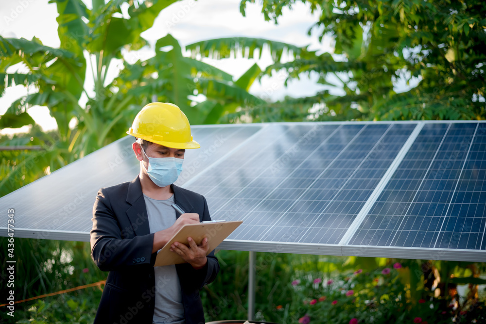 Young engineer pictured examining the operation of photovoltaic ...