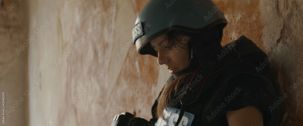 CU Portrait of Caucasian female war journalist wearing protective ...