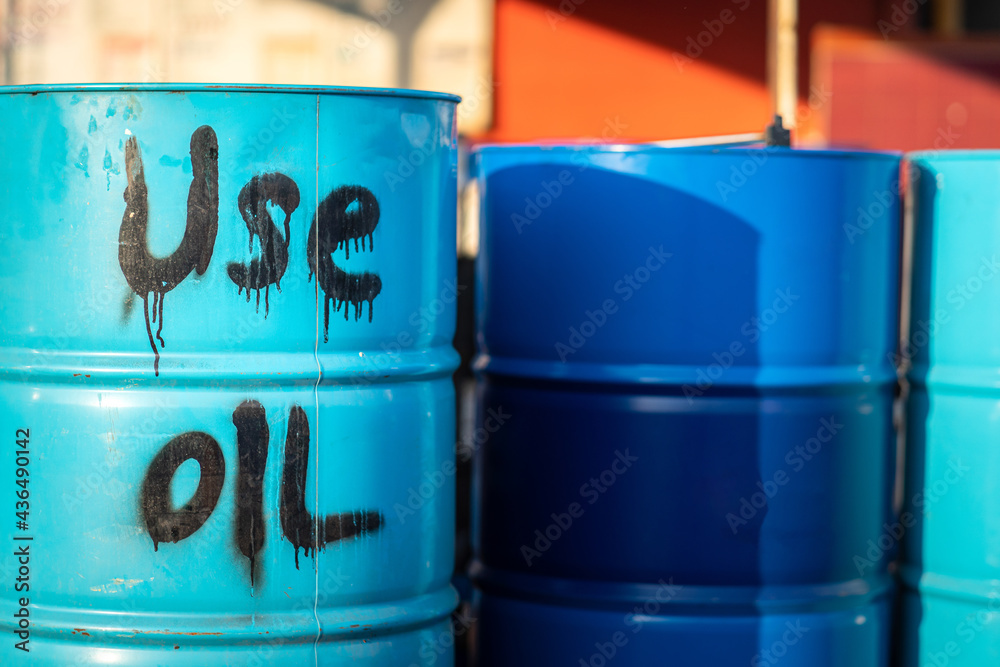 "Use oil" text label on the blue chemical barrel container which is ...