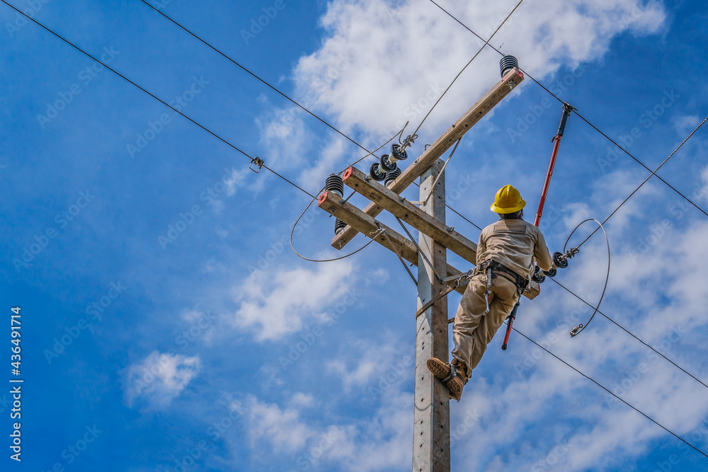 Photo & Art Print The power lineman use clamp stick (insulated tool) to ...