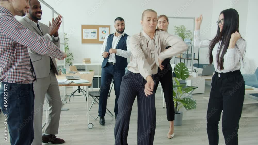 Flexible young woman is dancing at corporate party moving among ...