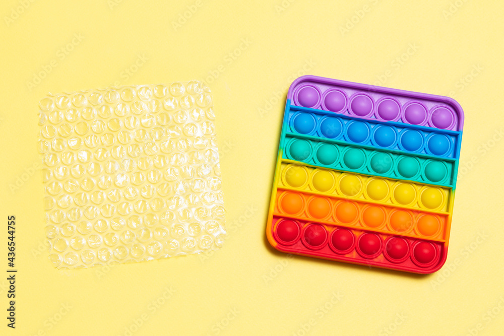 Rainbow Pop It Toy and Bubble Wrap on yellow background. Push Bubble ...