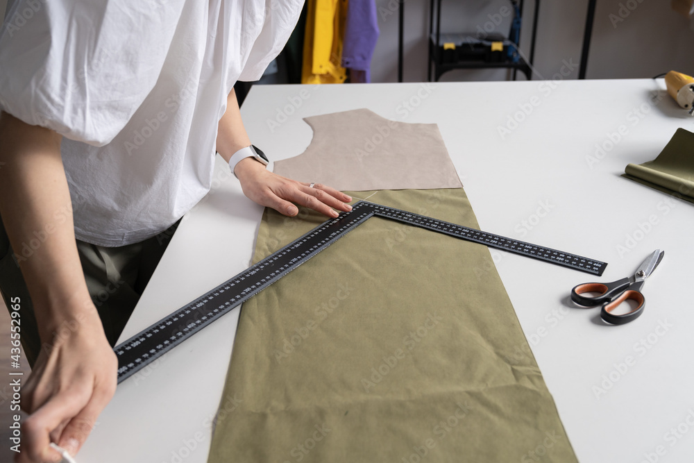 Tailor couturier measuring fabric. Closeup of professional sewer female ...