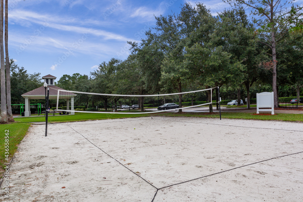 Beach volleyball court in a park surrounded by trees Stock Photo ...
