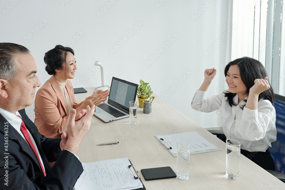Happy excited young woman celebrating getting dream job after interview ...