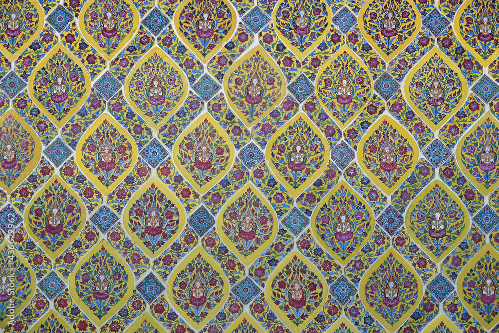 Thai pattern of buddha image surrounded by flowers on colorful wall ...