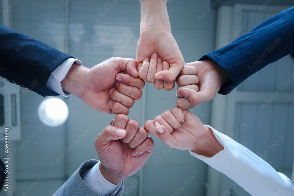 Businessman and woman putting hands fist join together, business ...