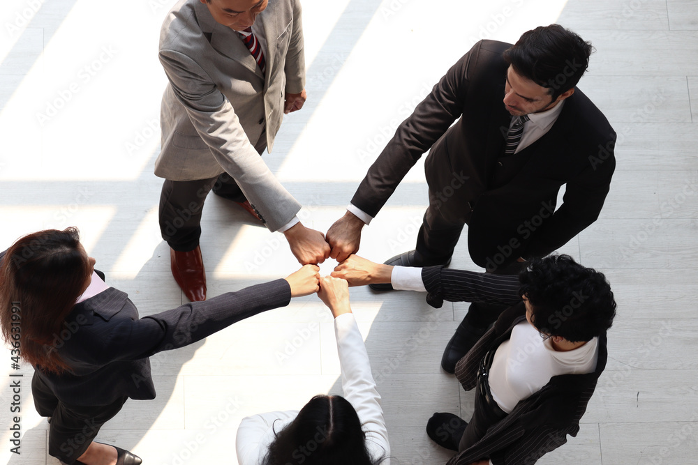 Overhead view of businessman and woman putting hands fist join together ...