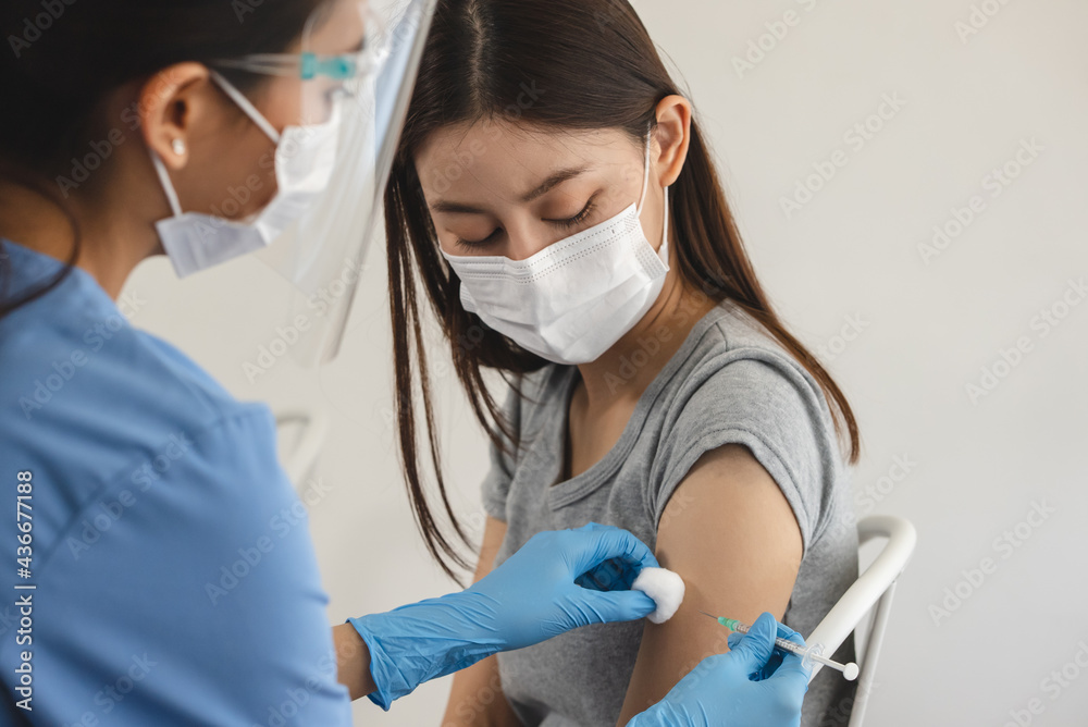People getting a vaccination to prevent pandemic concept. Woman in ...