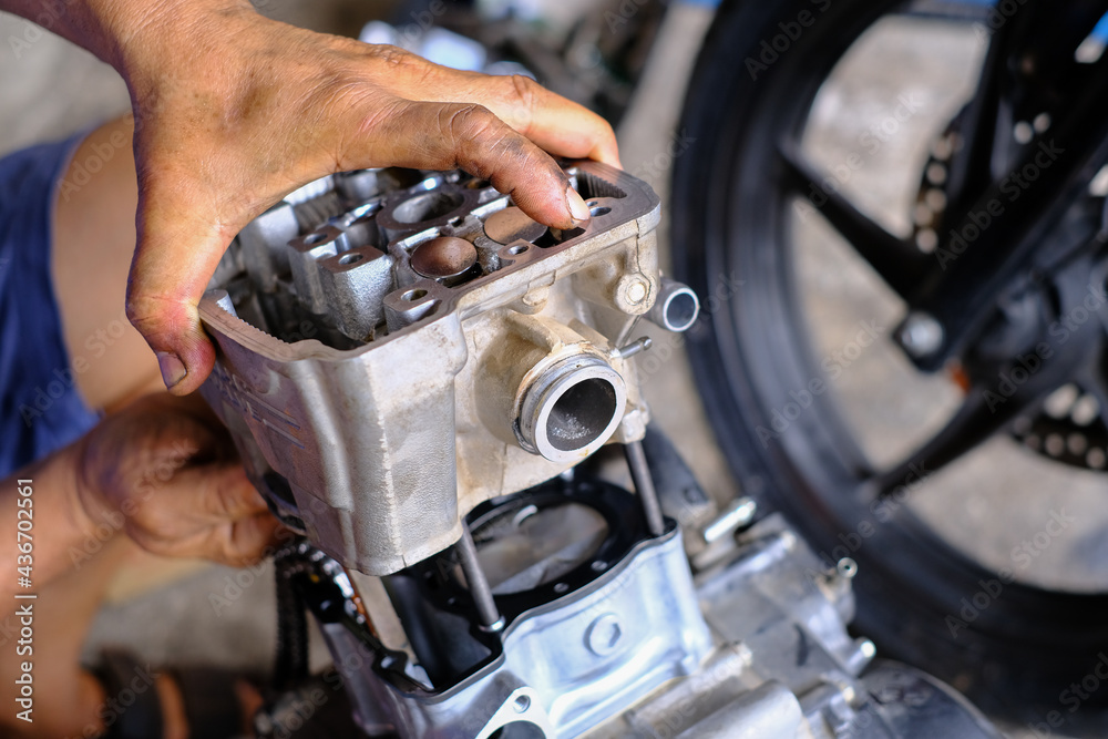 Assembling the cylinder head on a motorcycle engine by an engine ...