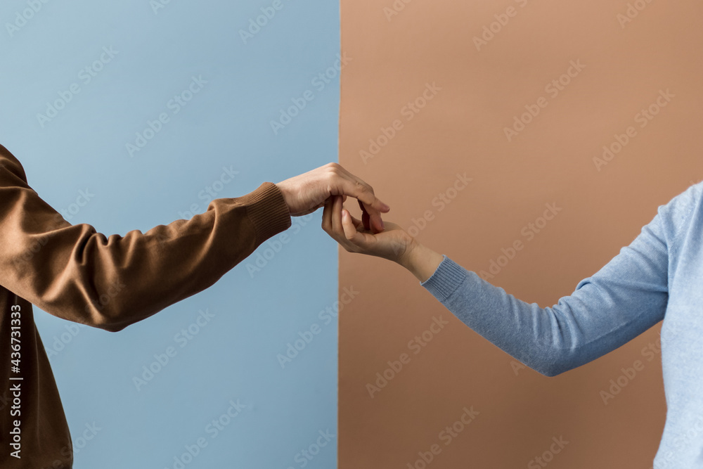 Two hands merge with tips of the fingers into a fist on different ...